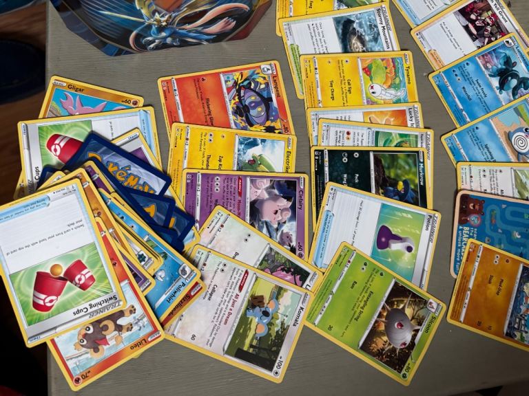 Pokémon trading card game Tin s trading cards with a collection of ...